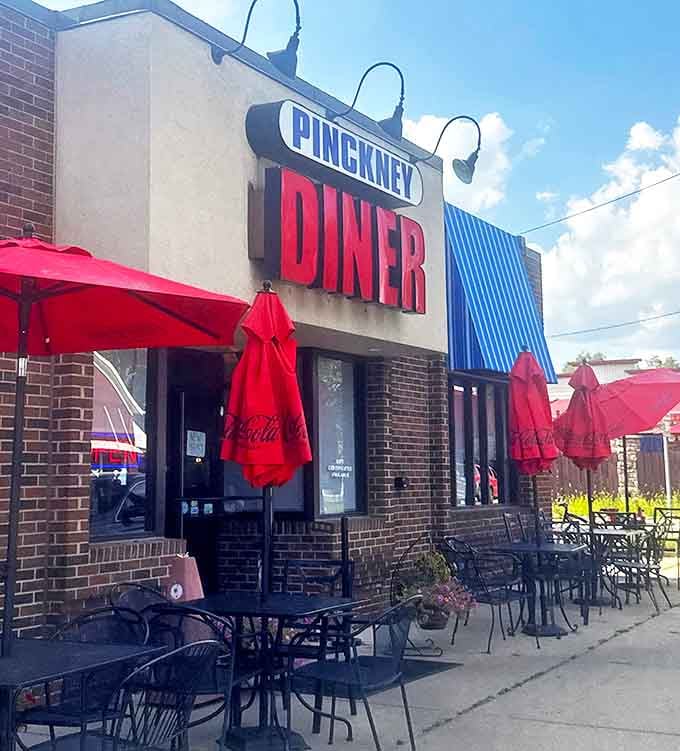 Red umbrellas provide cheerful shade for sidewalk diners &ndash; the perfect spot to watch Pinckney life unfold between bites.