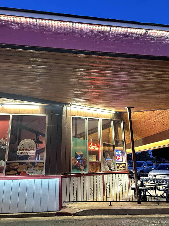 As evening falls, the warm glow of lights invites weary travelers and locals alike to pause for a taste of timeless American comfort.