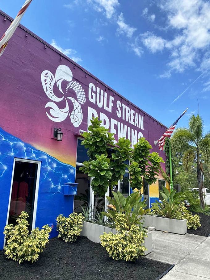 Tropical plants frame the entrance, creating an oasis of craft beer and pizza perfection in Fort Lauderdale's urban landscape.