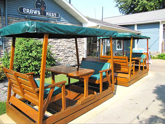 Charming wooden booths with canopies offer the perfect setting for enjoying lake breezes along with your meal during warmer months.