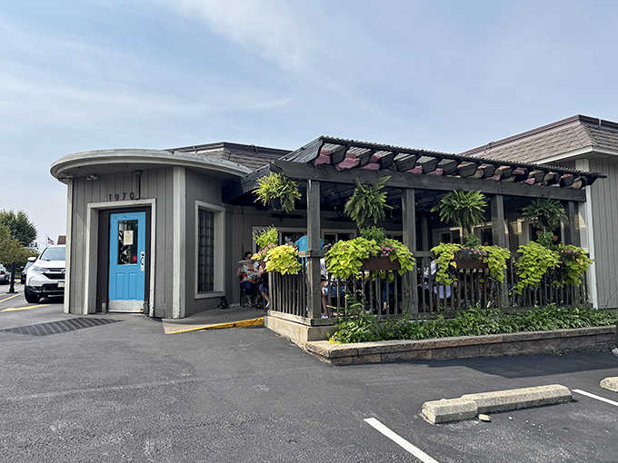 The exterior's unassuming charm, complete with that signature blue door and lush hanging plants, belies the culinary magic happening inside.