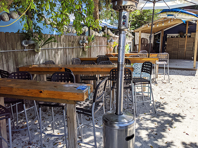 Sandy floors and wooden tables create barefoot luxury—the quintessential Florida dining experience where shoes are optional but appetite is mandatory.