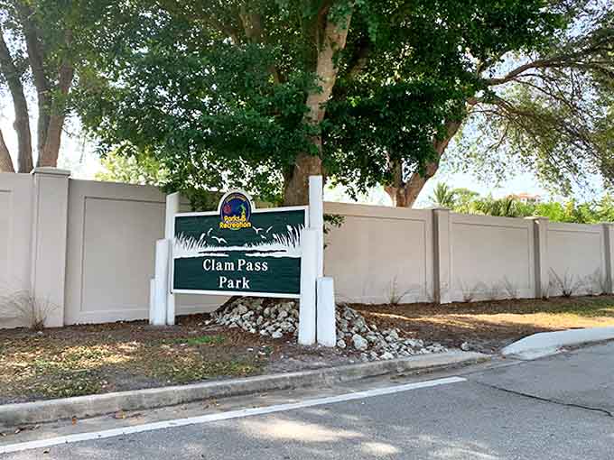 The Clam Pass Park entrance sign stands as the official gateway to adventure, promising memories more lasting than any souvenir shop trinket.