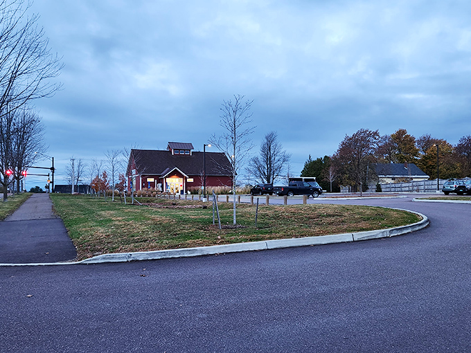 Even the parking lot has charm, with the red barn glowing like a beacon for hungry travelers as evening approaches.