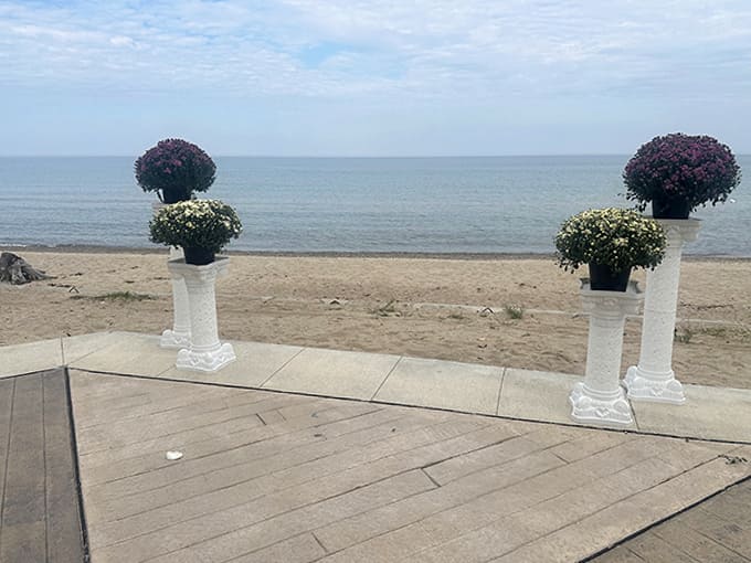 Elegant flower arrangements frame the perfect lake view, proving that sometimes the simplest decorations work best when nature does the heavy lifting.