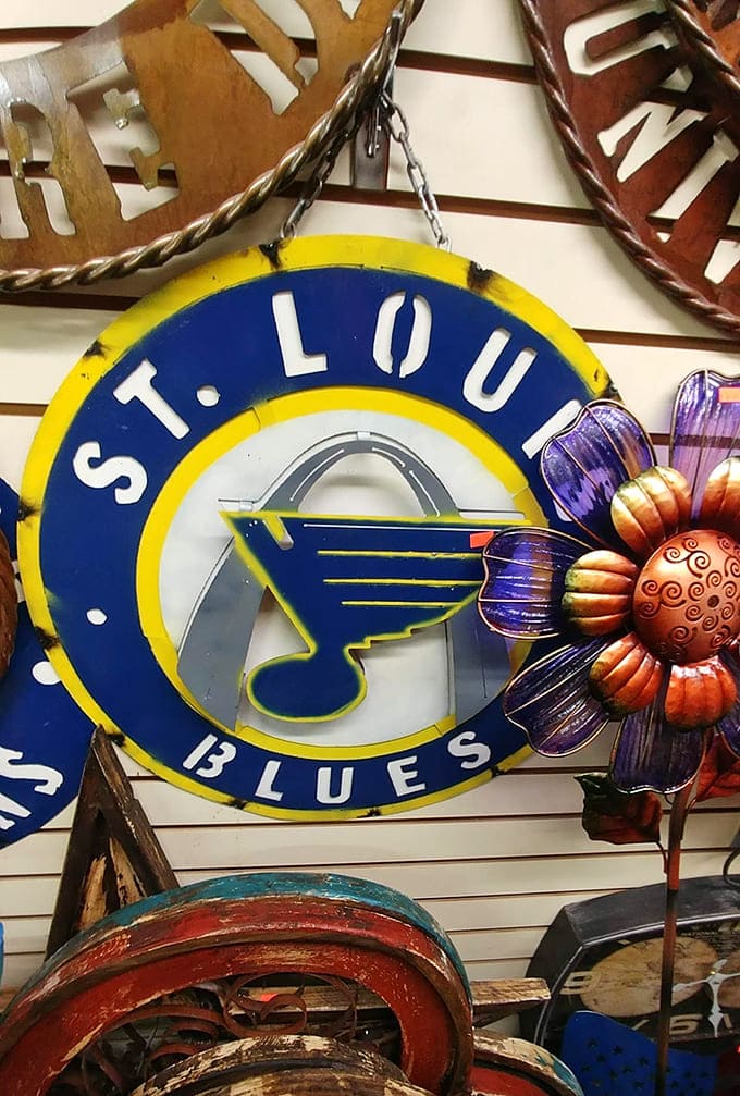 Sports fans rejoice at Red's collection of team memorabilia transformed into metal art, where loyalty to the Blues becomes permanent wall decor.