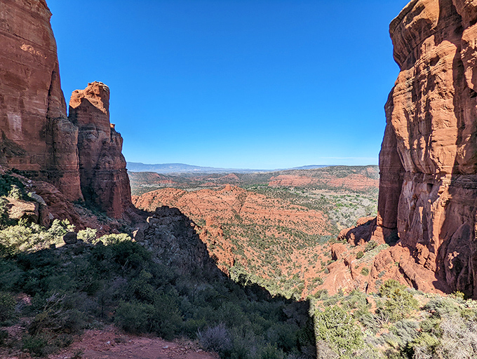Standing triumphant at Cathedral Rock's saddle, where achievement meets awe and hikers pause to soak in 360 degrees of wonder.