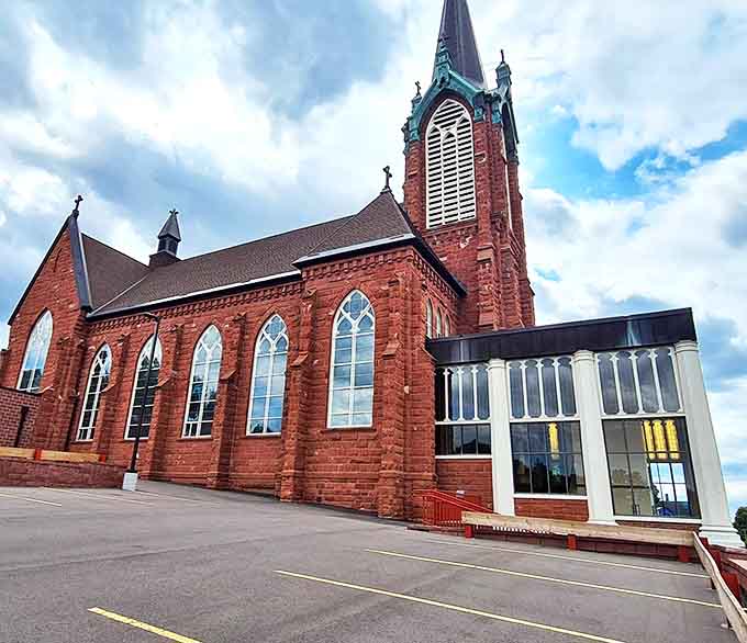 Saint Ignatius Loyola Church's striking red sandstone architecture stands as a spiritual beacon in Houghton, its spire reaching toward Michigan skies.