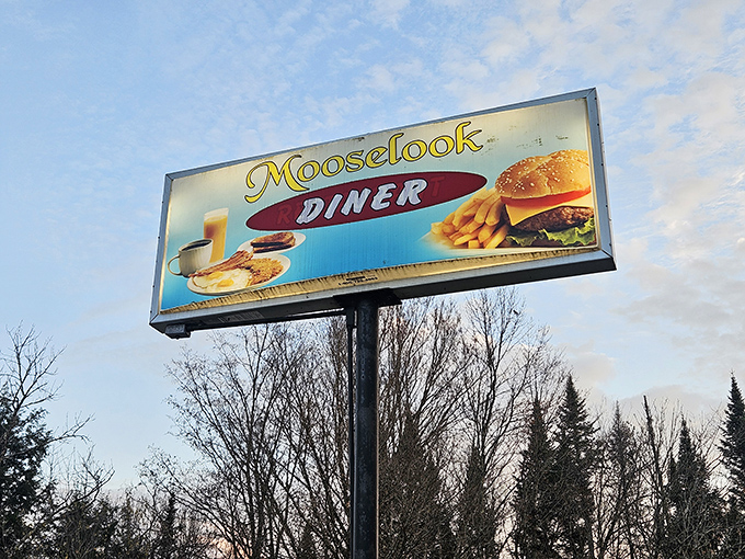 The roadside beacon that guides hungry travelers to burger paradise &ndash; Mooselook Diner's sign promises simple pleasures that exceed all expectations.