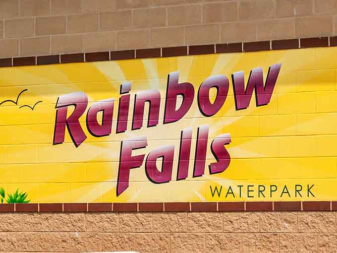 The Rainbow Falls signage welcomes visitors with bold letters that promise exactly what's inside: colorful, fun, and slightly over-the-top in the best way.