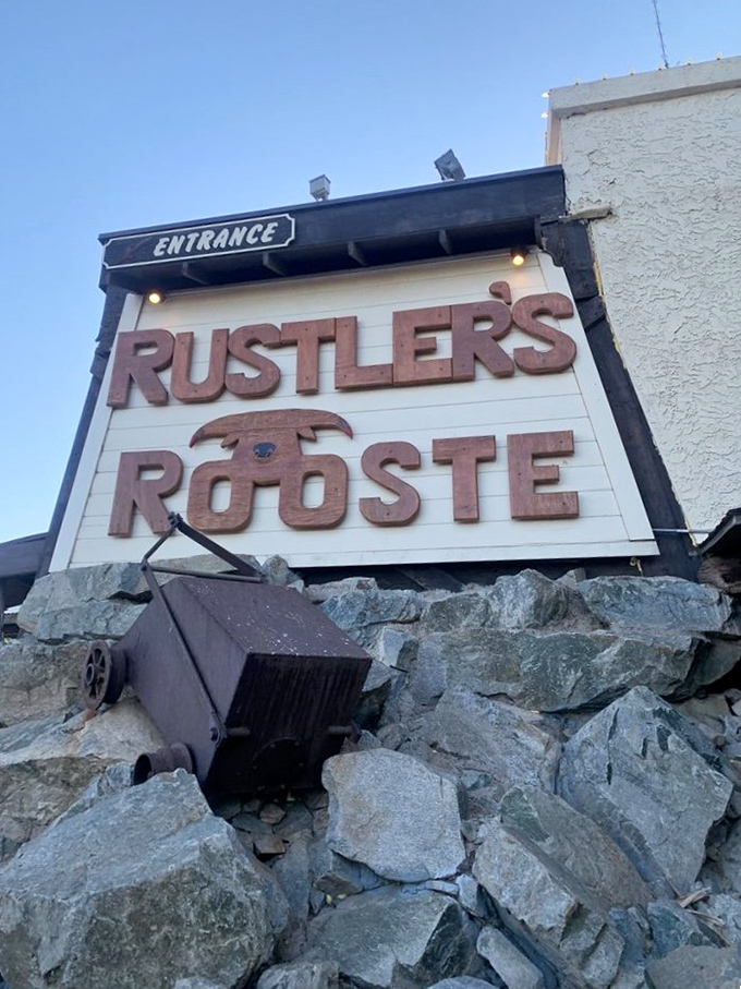 The entrance sign stands guard over rocky terrain, promising Western adventures and culinary treasures for those brave enough to enter.