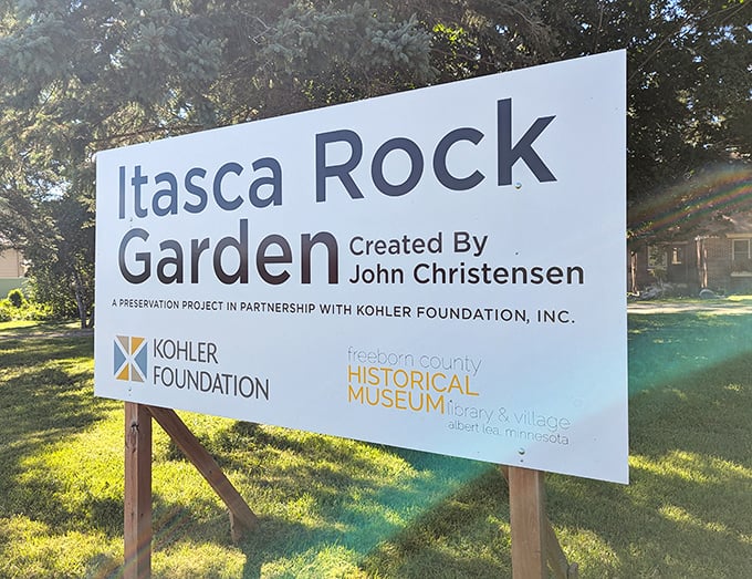 The garden signage credits artist John Christensen and preservation partners, acknowledging the collaboration required to maintain this quirky treasure for future generations of rock garden enthusiasts and curious wanderers.