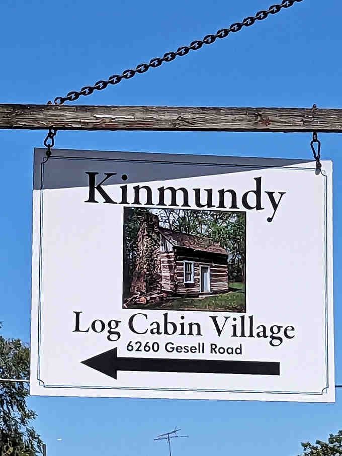 The village sign points the way to yesterday, inviting modern visitors to temporarily trade their digital world for a dirt path into history.