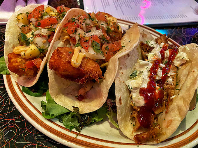 A trio of handheld happiness featuring crispy fish, tender chicken, and fresh toppings that bring Taco Tuesday to delicious life.