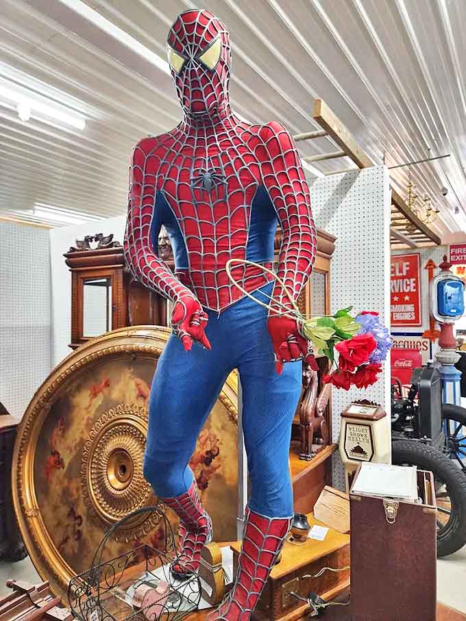 Even superheroes need antiques! This life-sized Spider-Man figure stands ready with roses, adding whimsical pop culture to vintage treasures.
