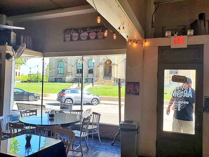 Morning light streams through windows, illuminating a corner where coffee, conversation, and community blend perfectly together.