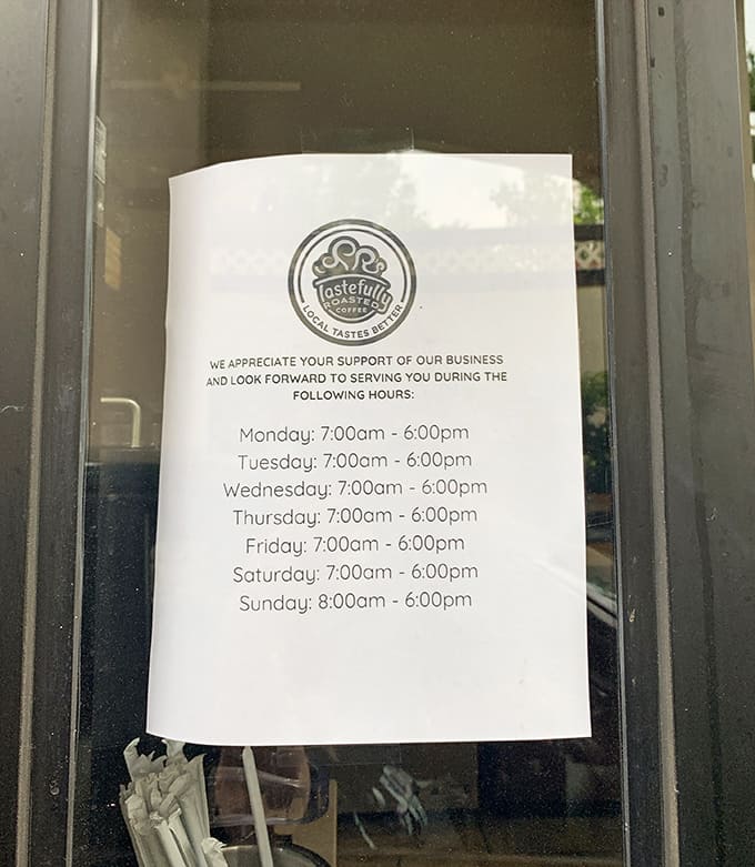Business hours posted clearly on the door, because nothing's worse than showing up for breakfast at 6:45 AM with high hopes.