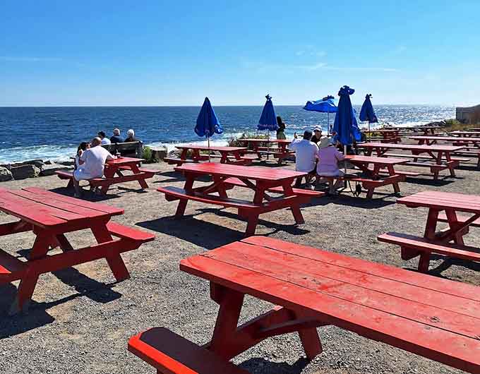 Red picnic tables scattered across the oceanfront property offer the ultimate Maine dining experience: fresh seafood, homemade pie, and endless Atlantic views.