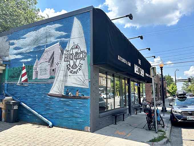 That vibrant mural celebrates lakeside living while The Malt Shop's modern facade hints at the timeless goodness waiting inside for hungry visitors.