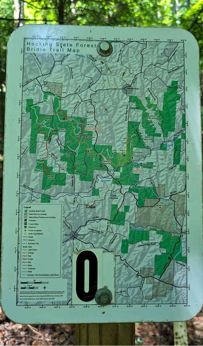 Trail maps throughout Hocking State Forest help adventurers navigate the extensive network of paths connecting natural wonders like Chapel Cave.