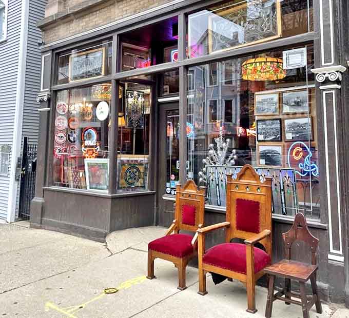 Throne-like wooden chairs with red upholstery invite sidewalk contemplation before entering this wonderland of nostalgia.