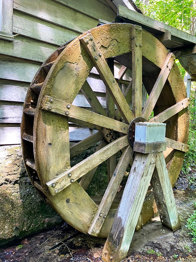 This historic wooden wheel stands as a reminder of Michigan's industrial past amid the garden's natural beauty.
