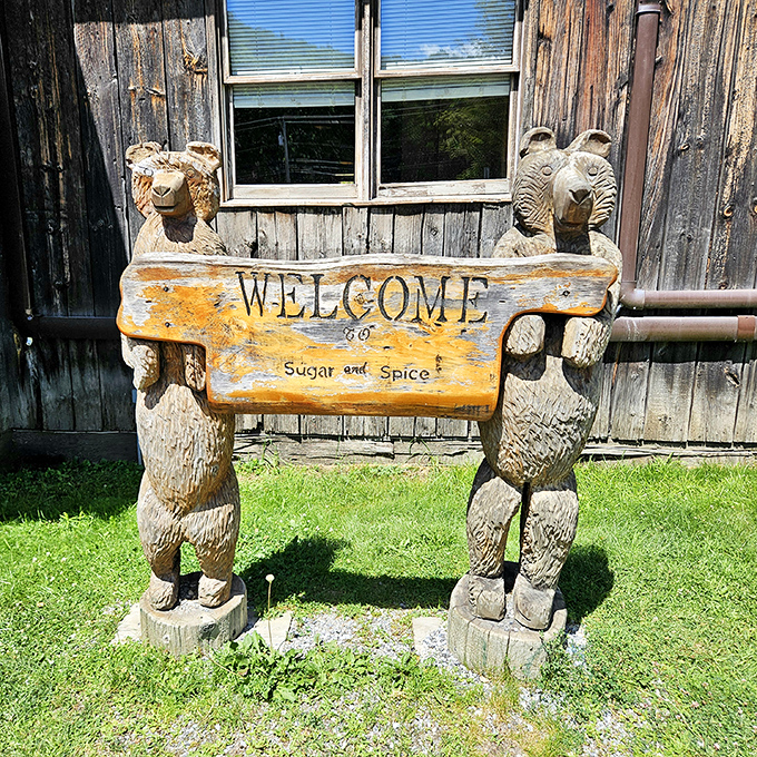 Carved wooden bears hold the welcome sign, their expressions suggesting they know exactly how good the pancakes are inside.