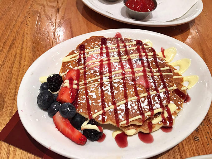 The signature Wildberry pancakes arrive loaded with fresh fruit, looking like a still life painting you're about to devour with zero regrets.
