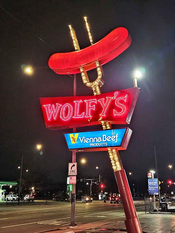 By night, the neon hot dog glows like a culinary lighthouse, guiding hungry souls to one of Chicago's most beloved street food institutions.
