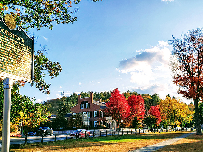 Woodstock Marker: Where history meets foliage! This heritage sign stands sentinel as crimson maples create the perfect backdrop for a lesson in Vermont history.