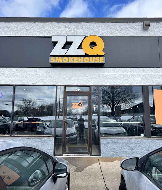 The storefront welcomes hungry visitors with bold signage that promises smoky goodness awaits inside those doors.