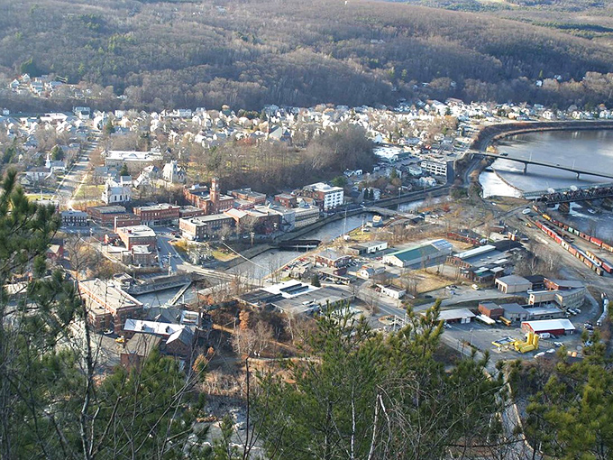 Bellows Falls spreads along the Connecticut River valley, its historic downtown nestled between rolling hills and flowing water.