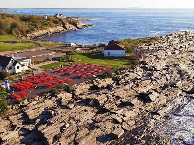 Aerial view reveals the restaurant's dramatic setting, where land meets sea in a spectacular rocky embrace.