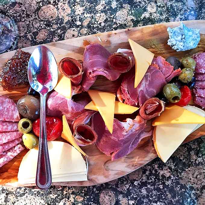 The charcuterie board – a wooden stage where Italian meats and cheeses perform their savory symphony, making conversation optional but appreciation mandatory.