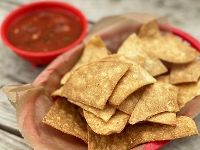 Crispy, warm tortilla chips ready for their dive into fresh, vibrant salsa – the opening act that sets the tone for the delicious meal to come.