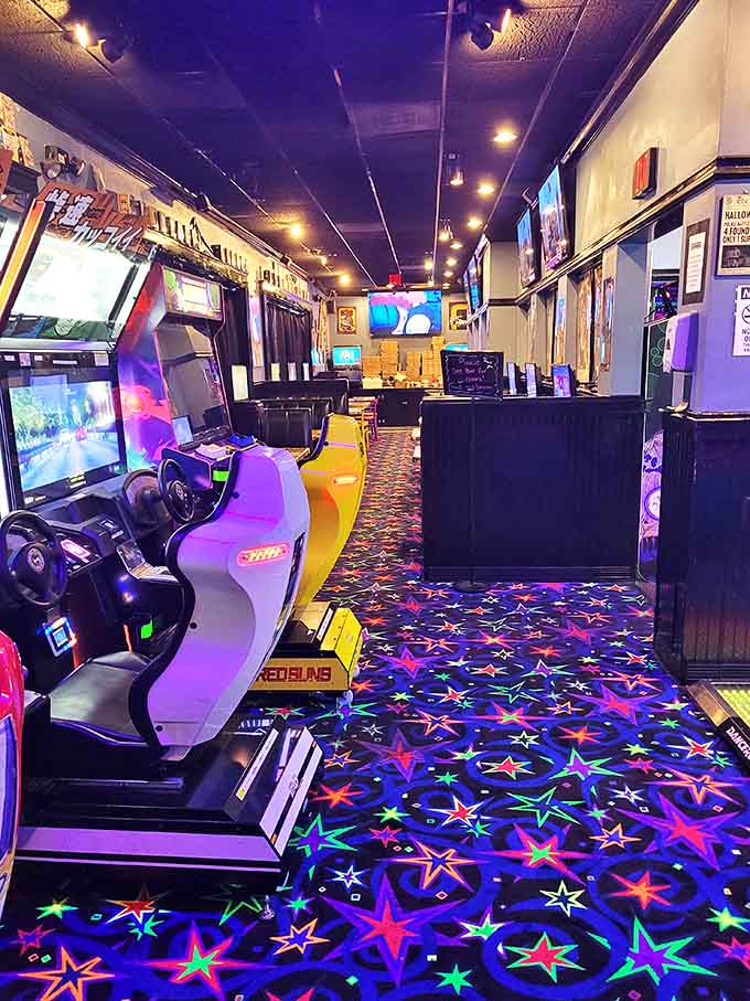 Neon-lit racing games and star-patterned carpet create an immersive gaming universe where time disappears faster than your tokens.