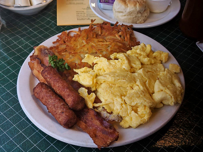 The breakfast of champions – fluffy scrambled eggs, crispy sausage links, and golden hash browns create a trifecta of morning comfort that fuels Prescott adventures.