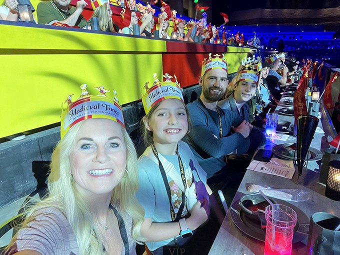 Families don paper crowns while enjoying the show, proving that medieval entertainment appeals to royalty of all ages.