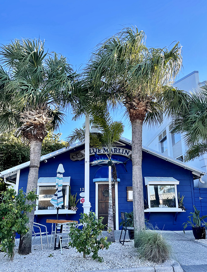 Palm trees stand sentinel beside the bright blue cottage, welcoming hungry visitors to one of Florida's true culinary treasures.