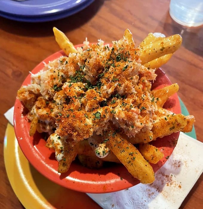 Garlic crab fries that defy description &ndash; crispy potatoes smothered in garlic butter and topped with sweet crab meat create a side dish that steals the spotlight.