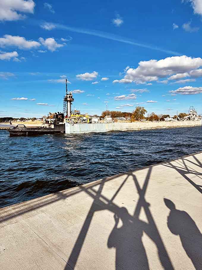 Perfect summer day at the Grand Haven Lighthouse, where puffy clouds dot the sky and the red tower pops against azure blue.