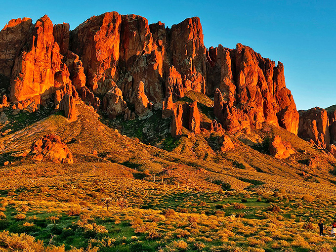 Sunset transforms the Superstitions into a fiery spectacle, their jagged silhouette burning against the evening sky.