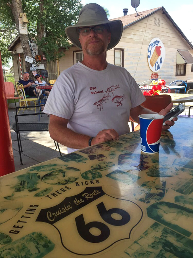 The outdoor dining area becomes an impromptu community of travelers, where strangers become friends over shared meals and road trip tales.