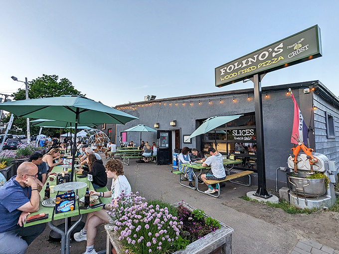 Outdoor tables fill with happy diners enjoying wood-fired pizza in Folino&rsquo;s lively, laid-back Burlington setting.
