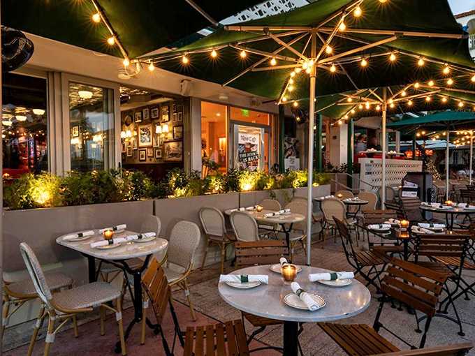 The outdoor patio transforms sidewalk dining into front-row seats for Ocean Drive's greatest show – people-watching under twinkling lights as Miami Beach life parades past.