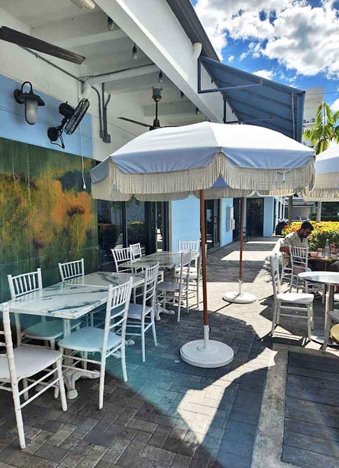 The full exterior with picnic tables waiting for fair-weather feasting &ndash; barbecue always tastes better with a side of fresh air.