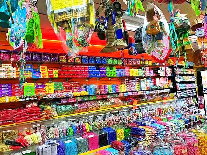 Piñatas hang from the ceiling like colorful sugar chandeliers – candy-filled promises that some celebrations are better when they end with a satisfying smash.