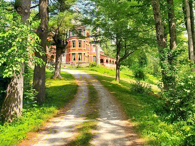 Winding pathways through lush greenery lead to the castle, building anticipation with every step toward this architectural marvel.