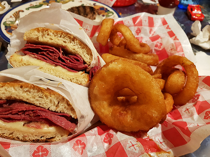 Towering pastrami on fresh bread with golden onion rings &ndash; proof that this joint's culinary talents extend well beyond pizza.