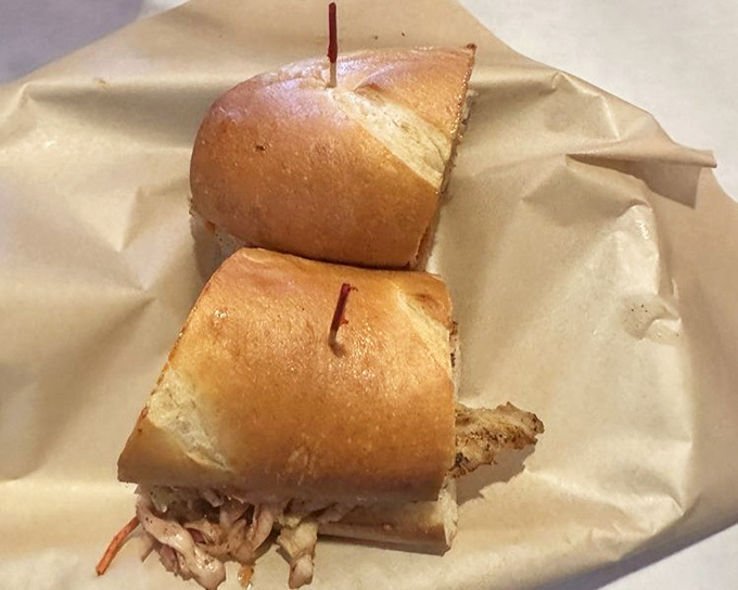 A po'boy sandwich cut in half reveals generous fillings &ndash; the perfect handheld solution when you can't decide between BBQ and Cajun.